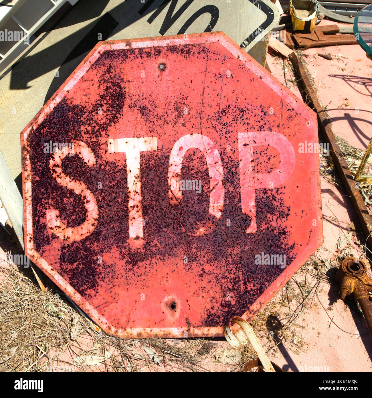 Rusty old stop sign on ground Stock Photo - Alamy
