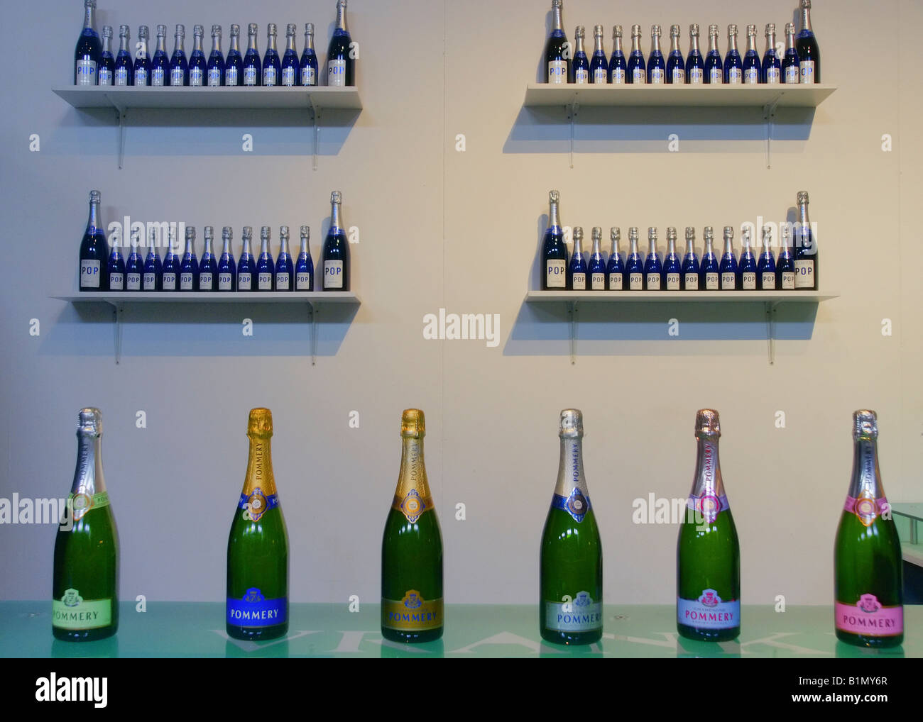A line of Champagne bottles in different colors at the Pommery Winery ...