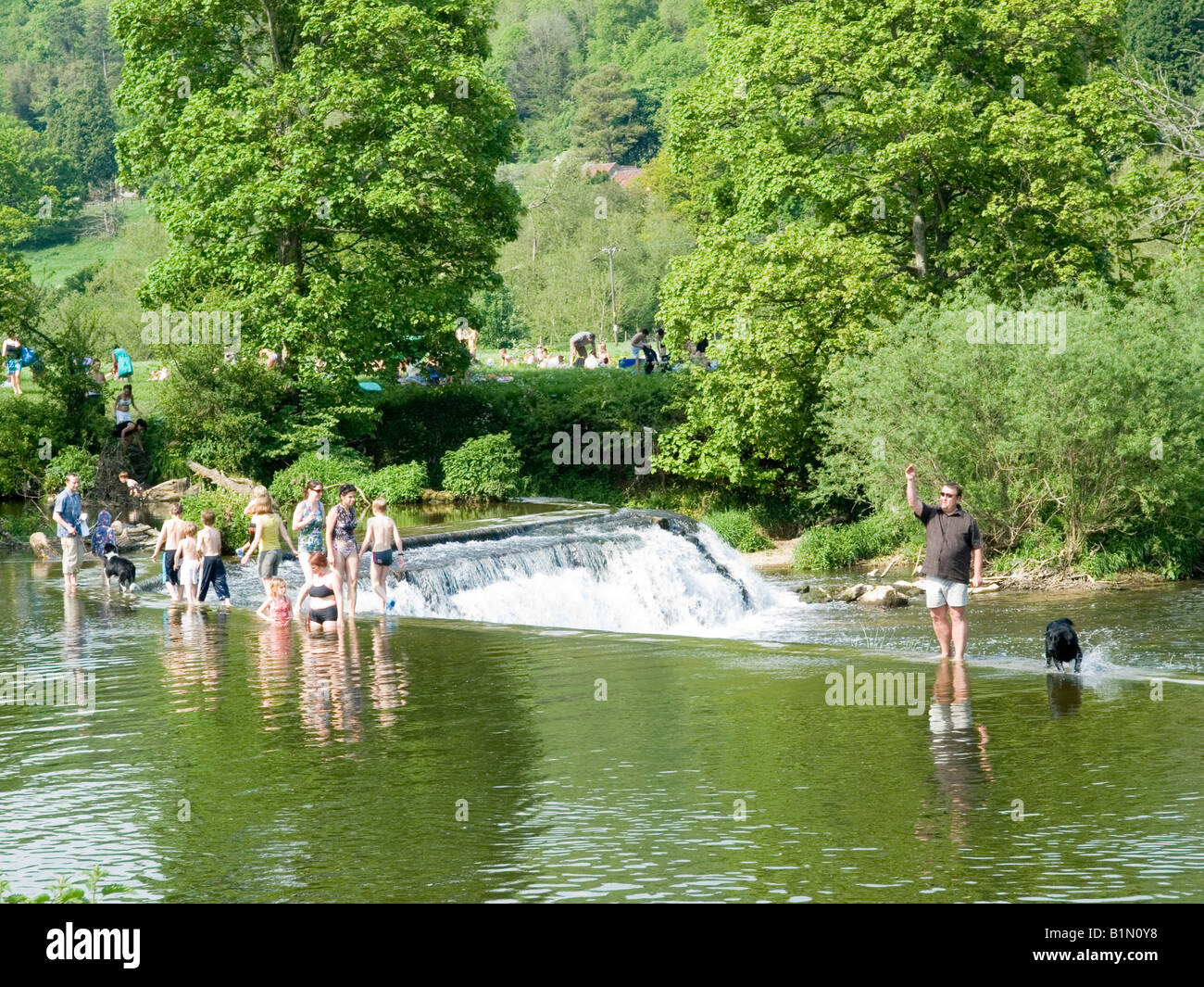 People enjoying a sunny day on the River Avon at Claverton Weir, Bath ...