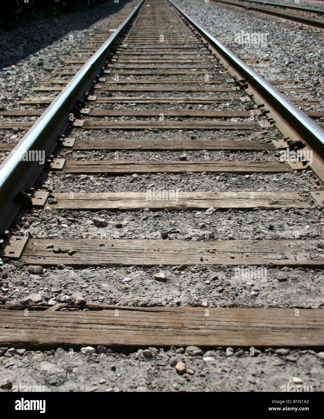 Railroad lines in a rocky road Stock Photo - Alamy