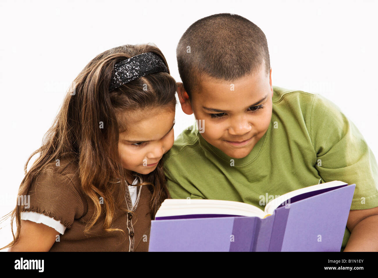 Boy and girl reading book together Stock Photo - Alamy