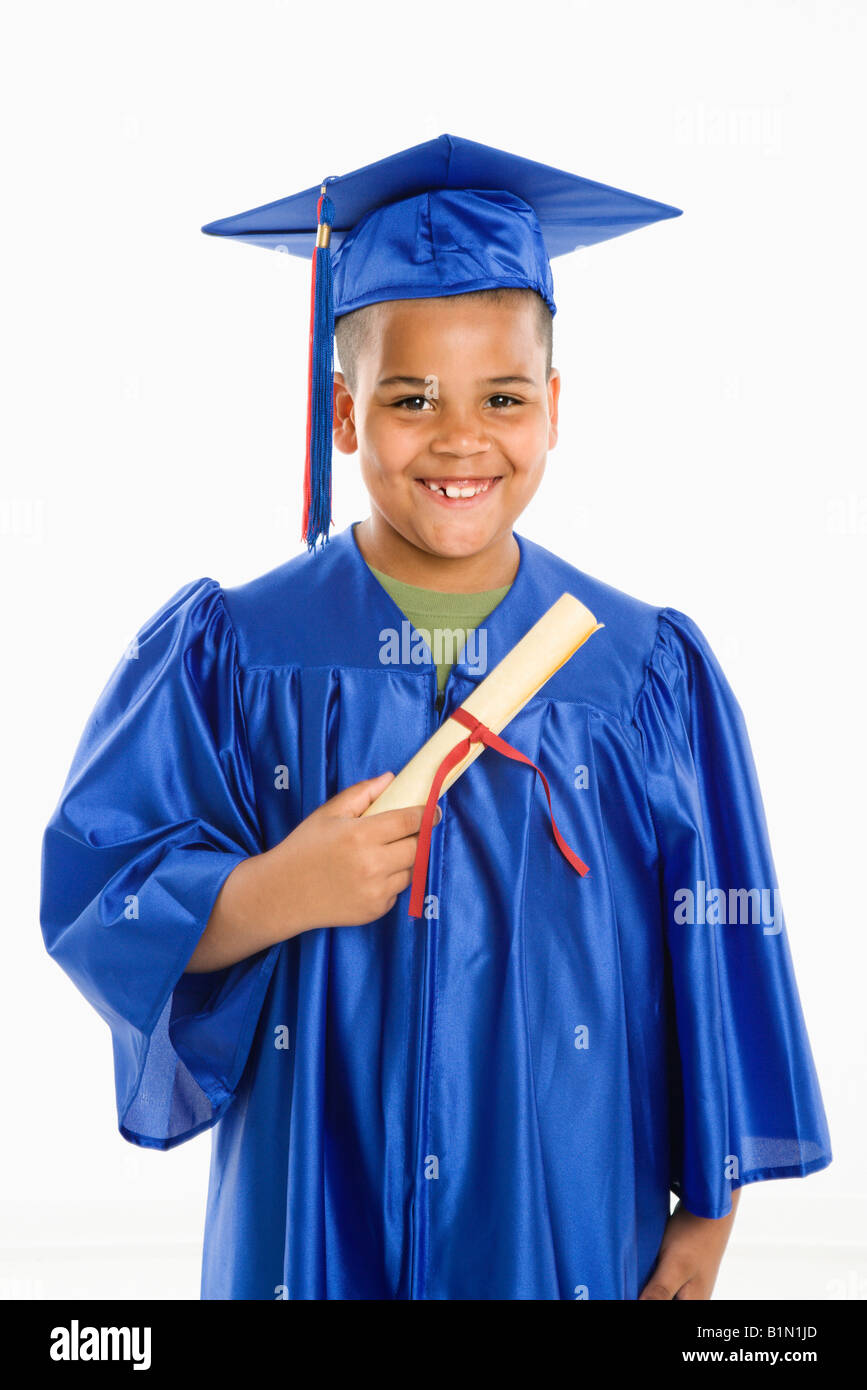 Young boy wearing blue graduation gown holding diploma Stock Photo - Alamy