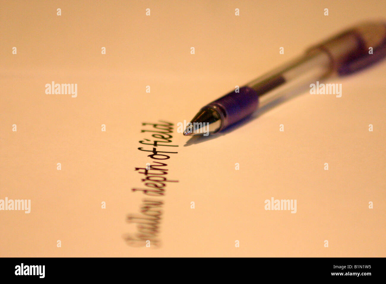Written text 'depth of field', showing shallow depth of field with pen ...