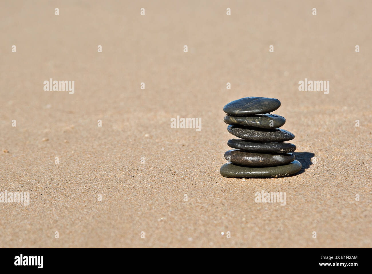 small pile of stones in tower on the beach Stock Photo - Alamy
