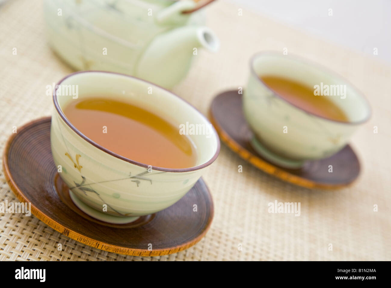 Japanese style tea cups filled with tea Stock Photo - Alamy