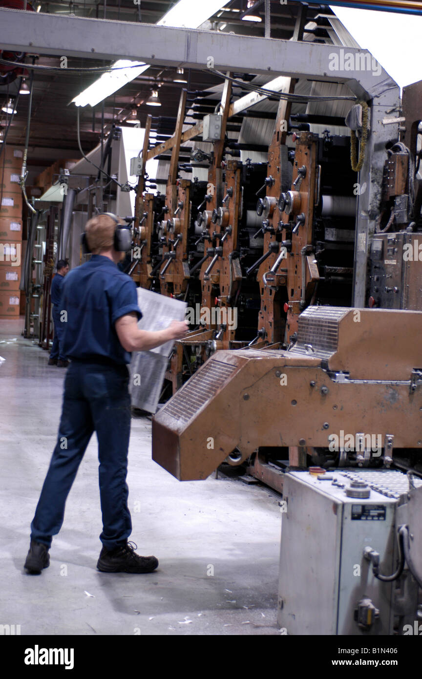 Pressman by the Quad Stack printing machine Stock Photo - Alamy