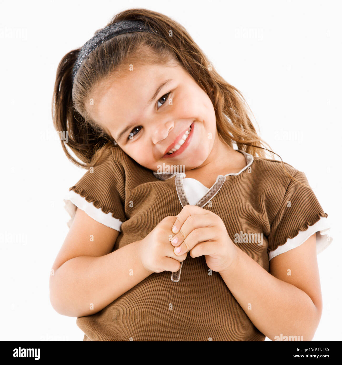 Cute little hispanic girl standing smiling at viewer Stock Photo - Alamy