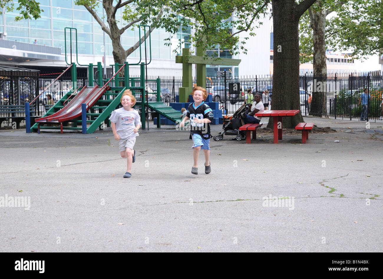 Boys running in a New York City playground Stock Photo - Alamy