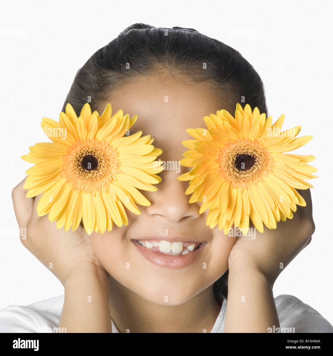 Close-up of a girl hiding her face with flowers and smiling Stock Photo ...