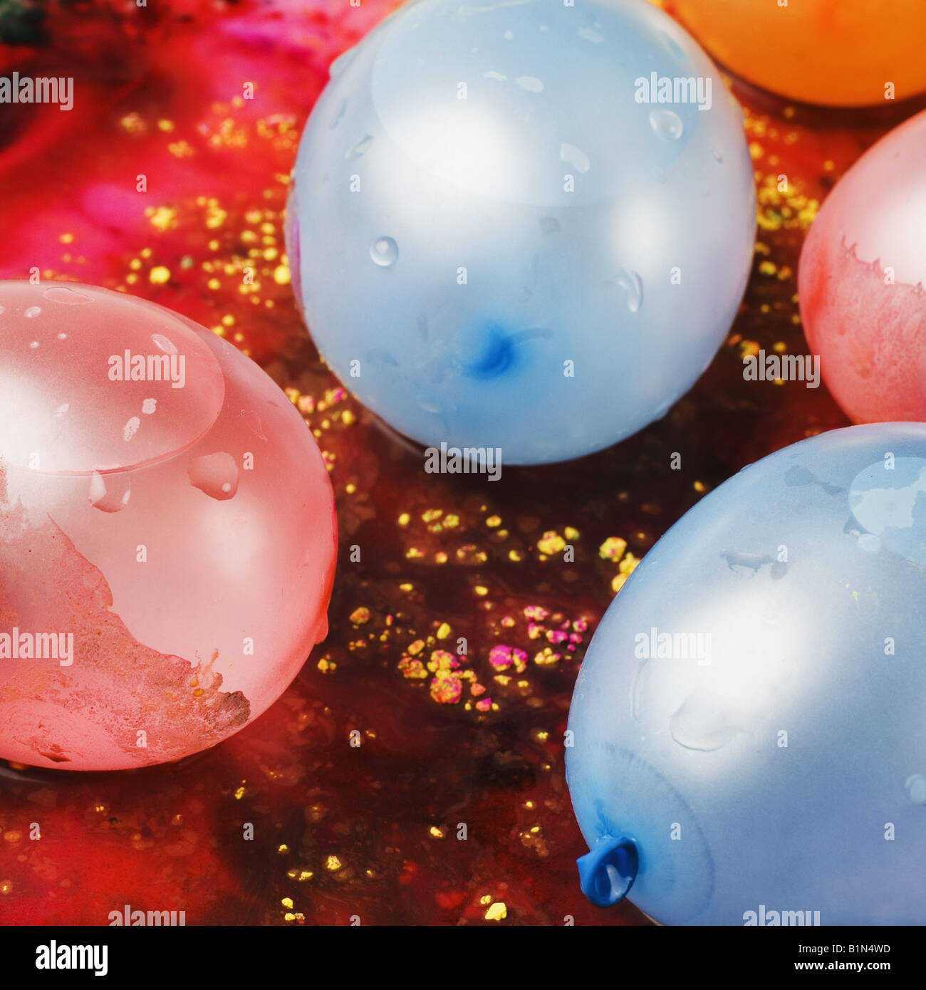 High angle view of water bombs on multi-colored powder paint Stock ...