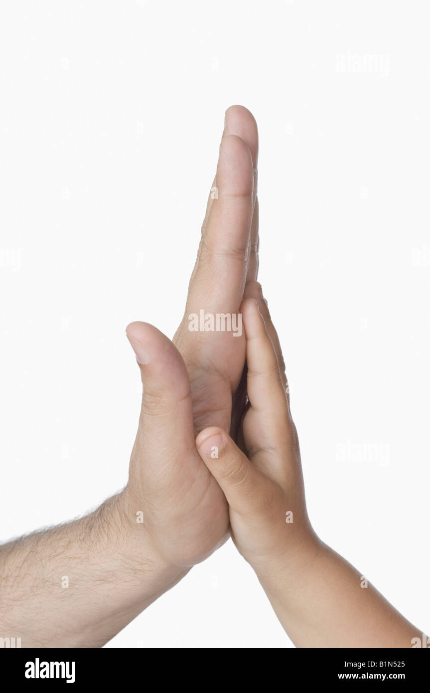 Close-up of a man's hand touching a child's hand Stock Photo - Alamy