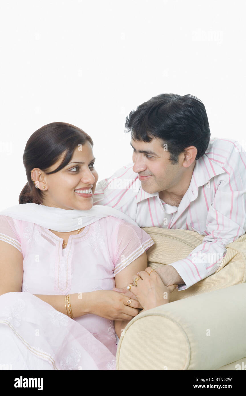 Mid adult couple looking at each other and smiling Stock Photo - Alamy