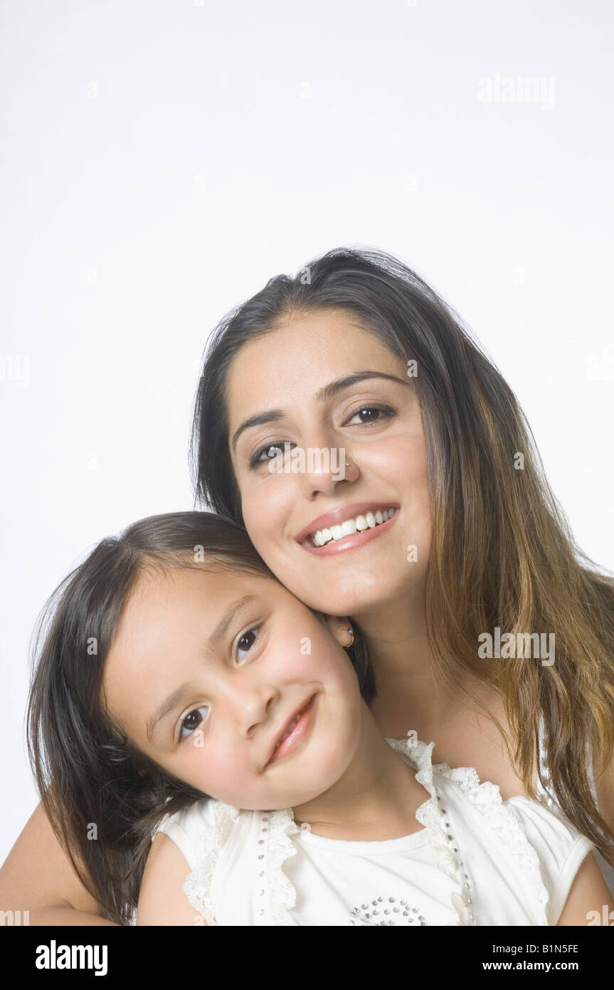 Portrait of a young woman and her daughter smiling Stock Photo - Alamy