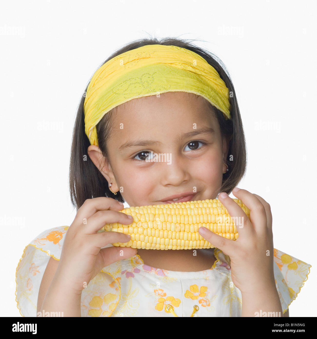 Portrait of a girl eating corn Stock Photo - Alamy