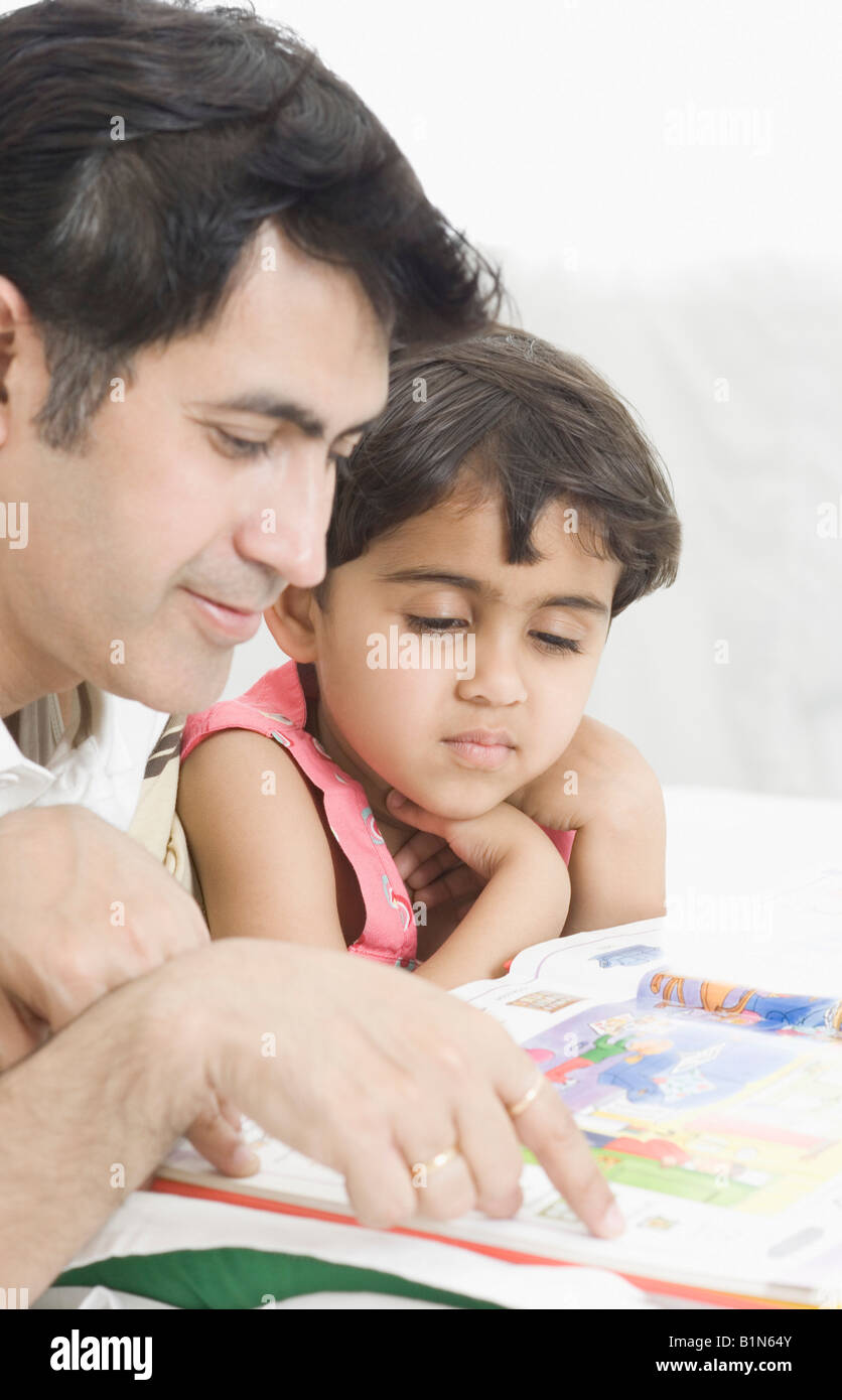 Close-up of a mid adult man teaching his daughter Stock Photo - Alamy