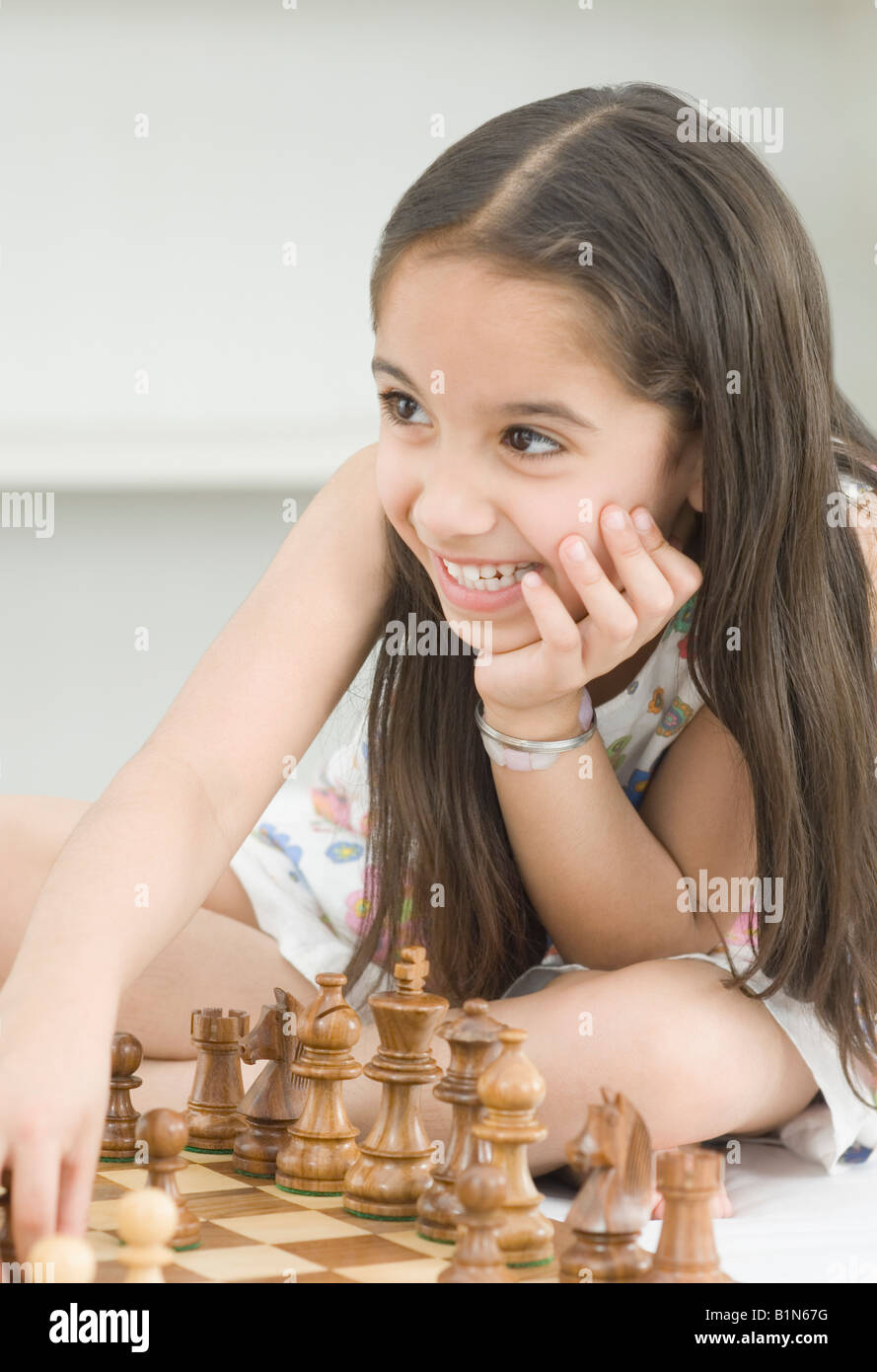 Close-up of a girl playing chess and smiling Stock Photo - Alamy