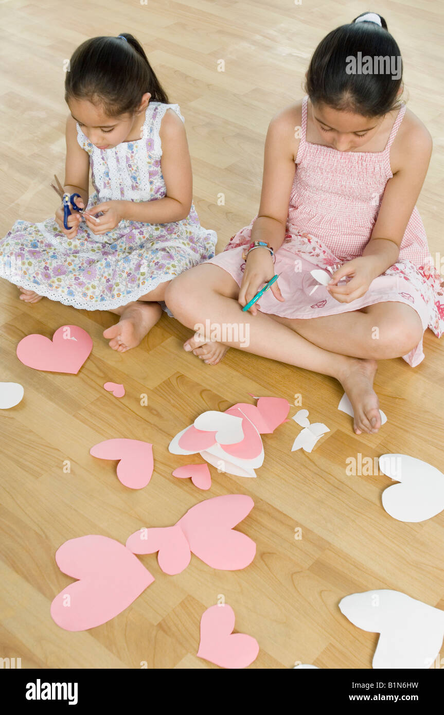 High angle view of two girls making greeting cards Stock Photo - Alamy