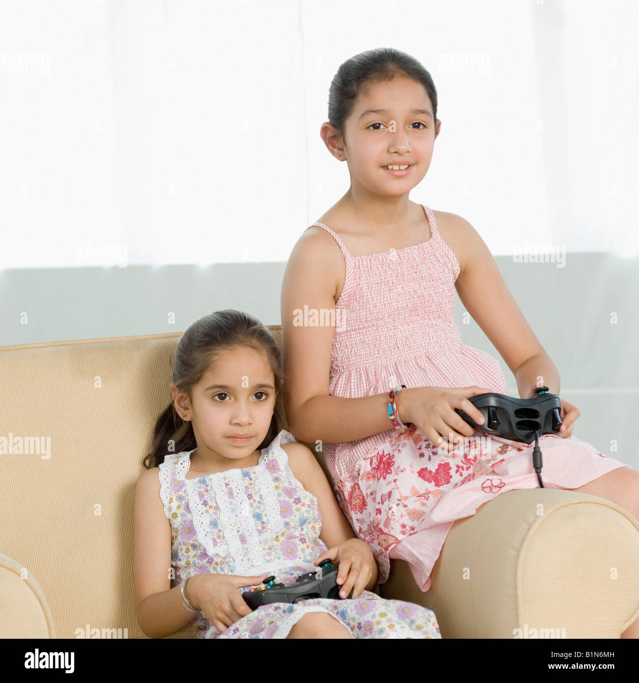 Two girls playing video game Stock Photo - Alamy
