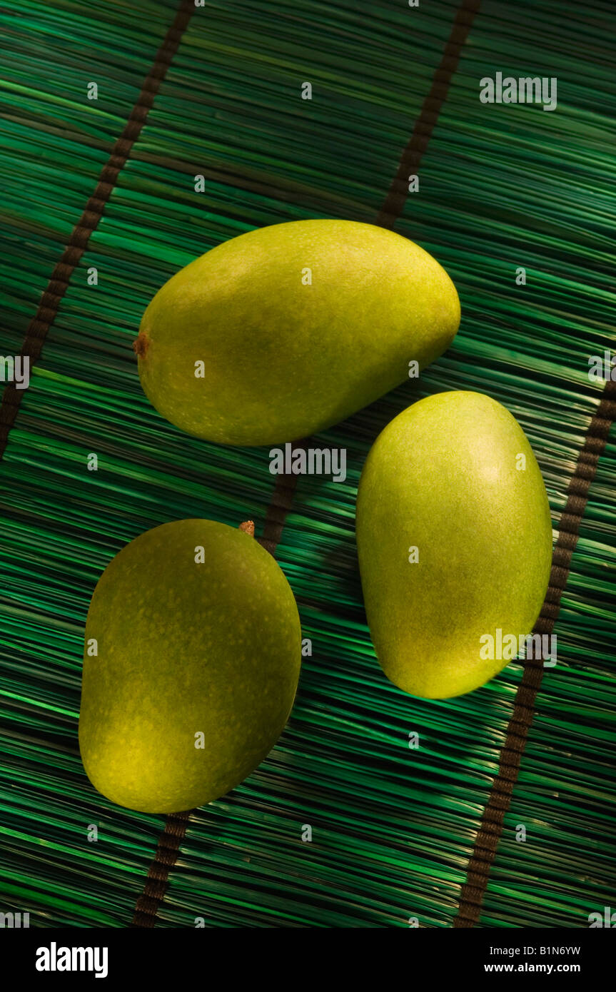 Close-up of three mangoes on a place mat Stock Photo - Alamy