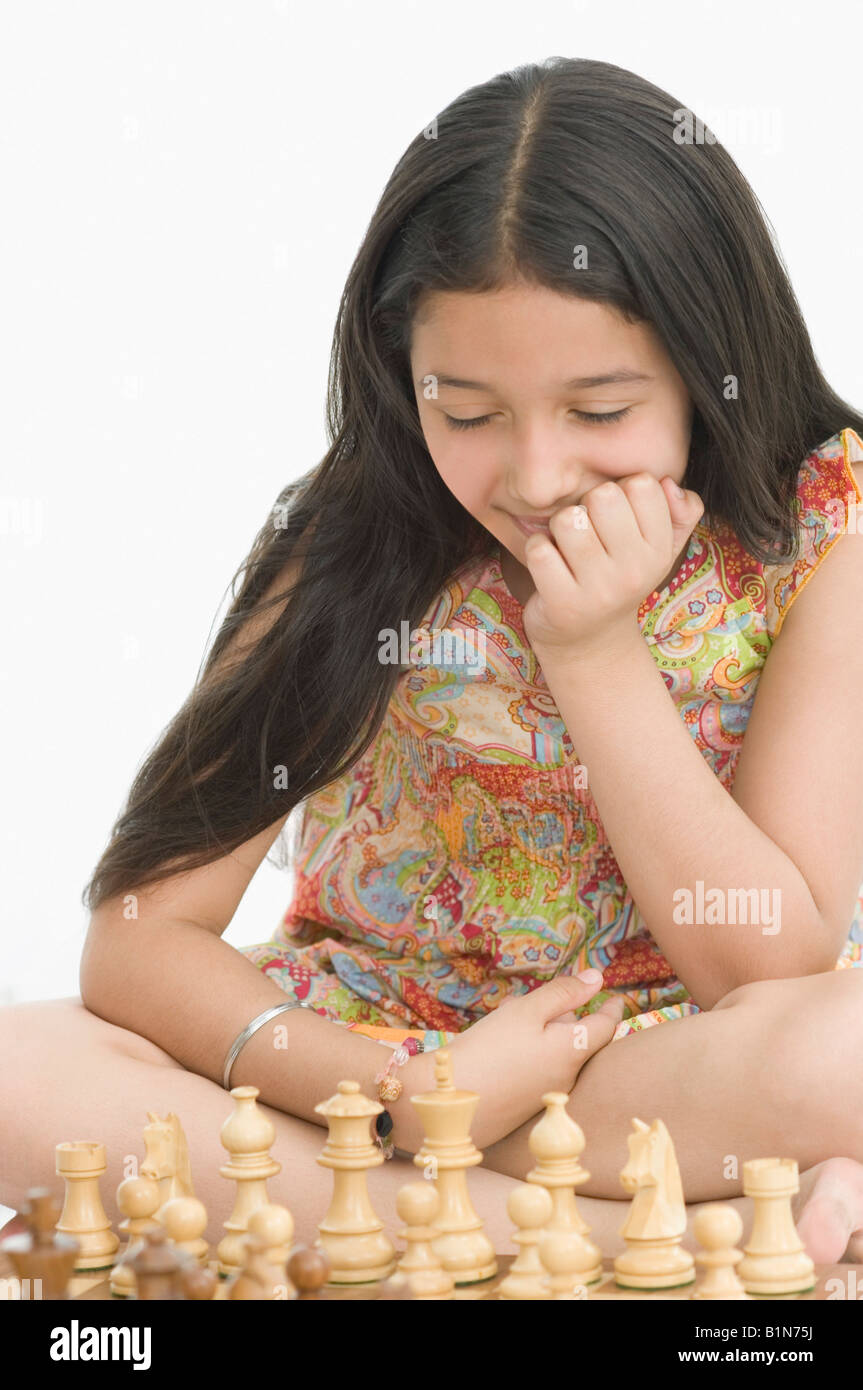 Close-up of a girl playing chess and smiling Stock Photo - Alamy