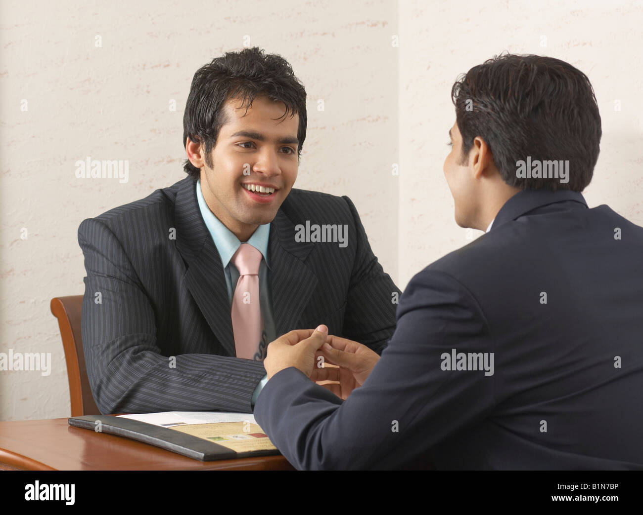 Two businessmen discussing in a hotel room Stock Photo - Alamy