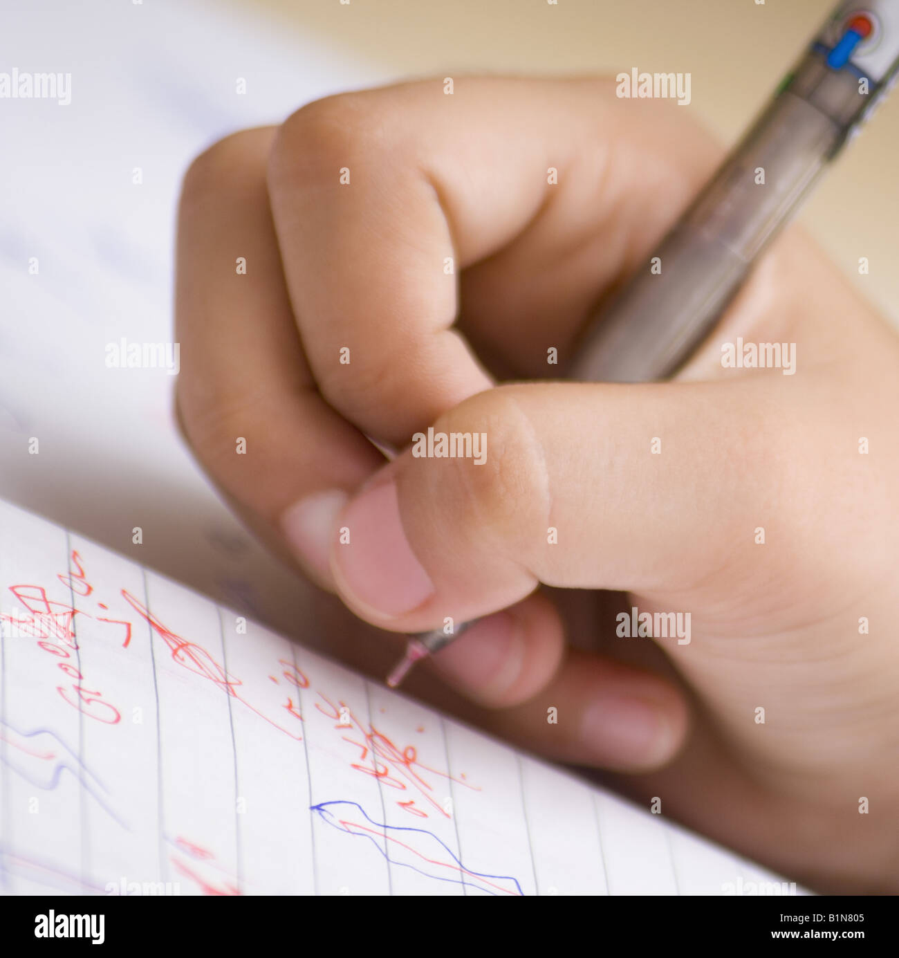 Close-up of a child's hand writing with a pen Stock Photo - Alamy
