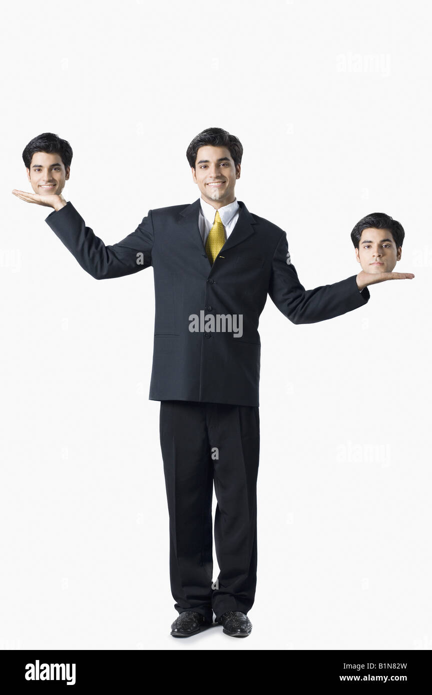 Portrait of a businessman balancing two heads on his palm Stock Photo ...