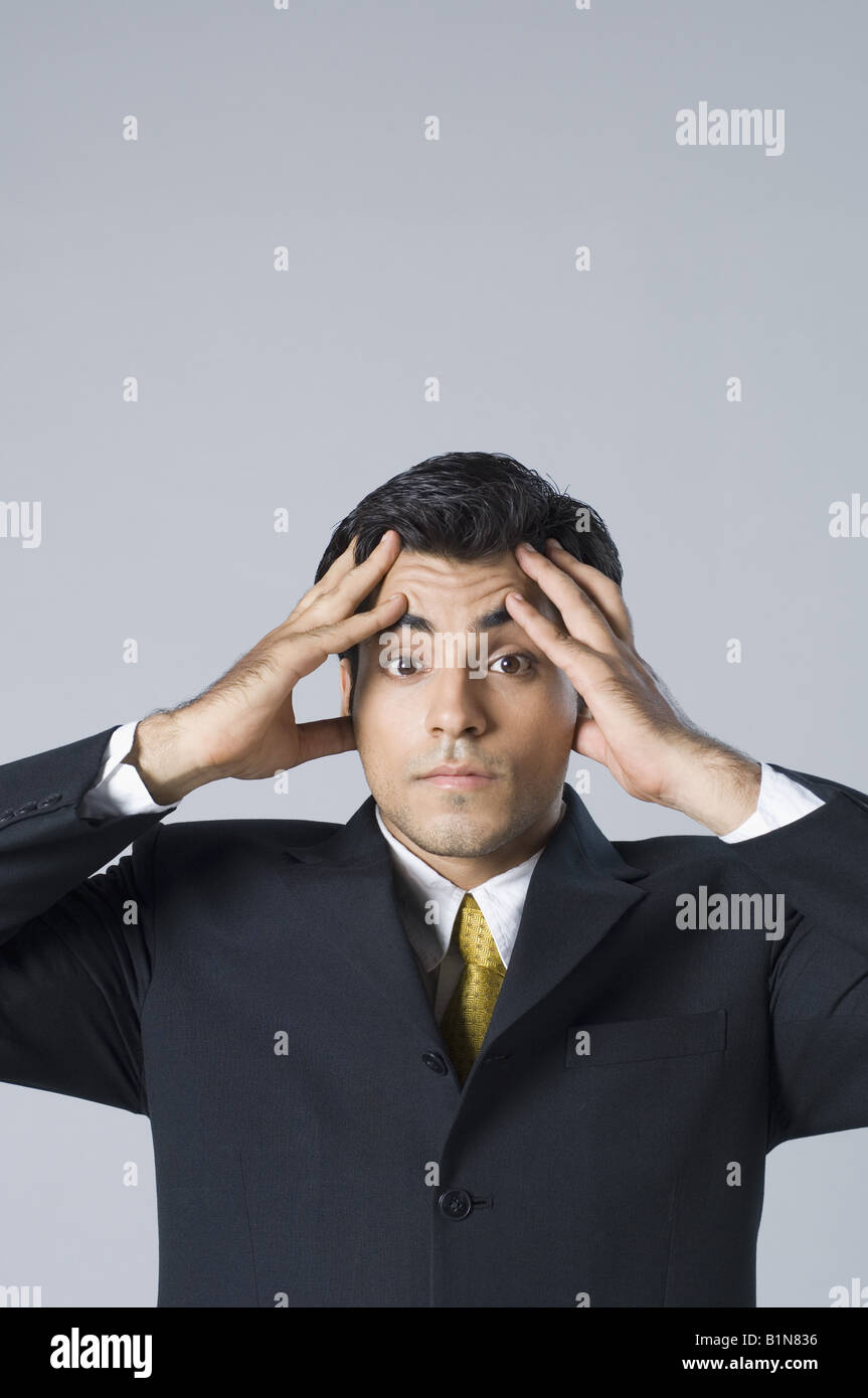 Portrait of a businessman suffering from a headache Stock Photo - Alamy