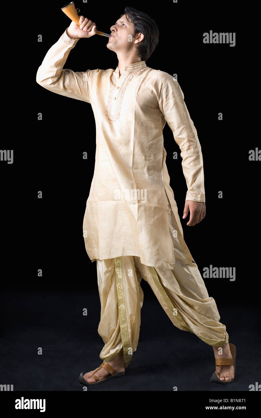 Young man playing a bugle Stock Photo - Alamy