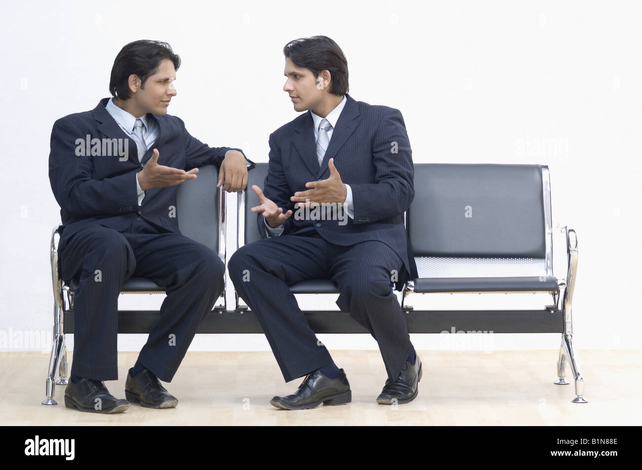 Two businessmen talking to each other Stock Photo - Alamy