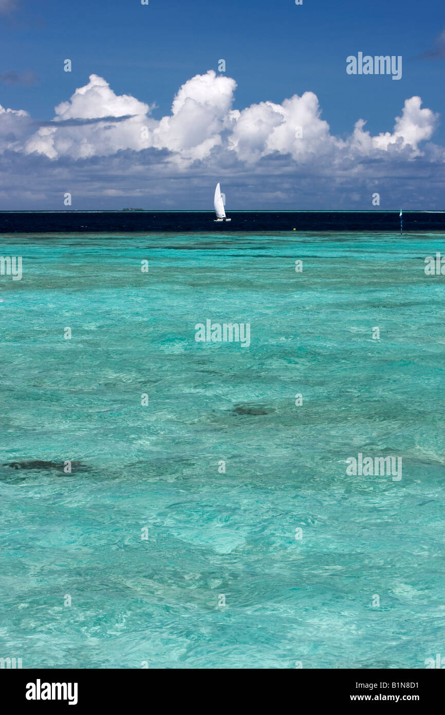 distant view of sailing yacht on tropical island Stock Photo - Alamy