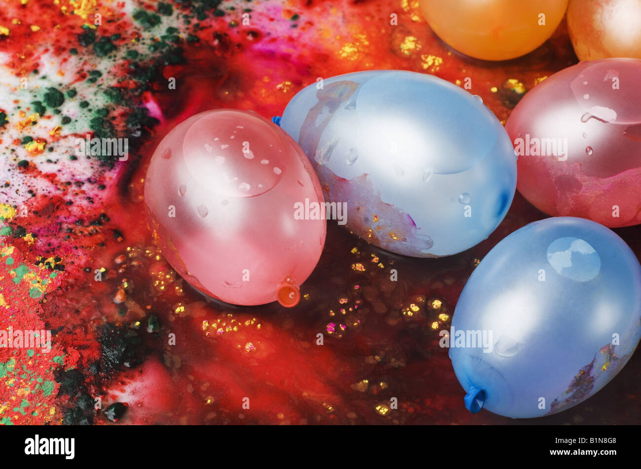 High angle view of water bombs on multi-colored powder paint Stock ...