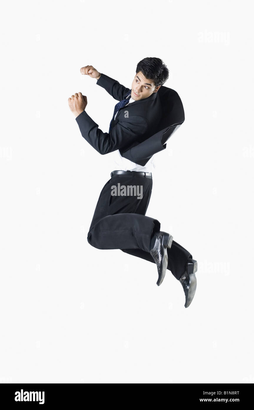 Side profile of a businessman jumping Stock Photo - Alamy