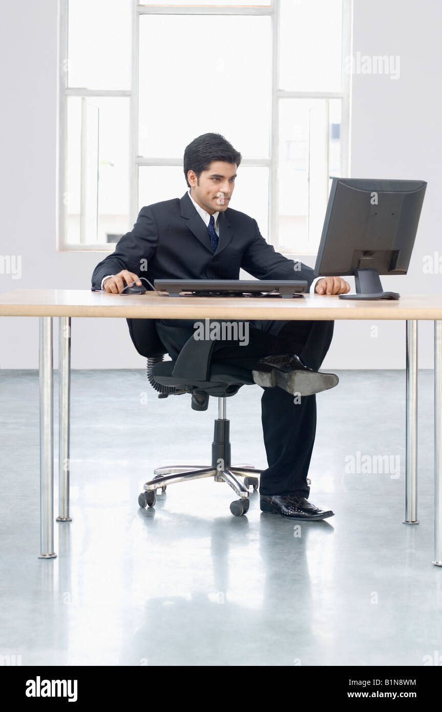 Businessman working on a desktop PC in an office Stock Photo - Alamy