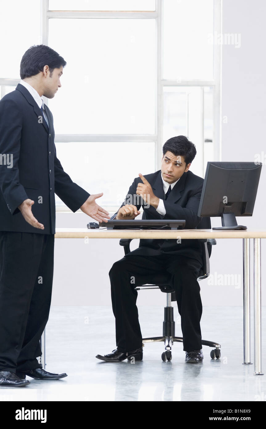 Two businessmen discussing in an office Stock Photo - Alamy