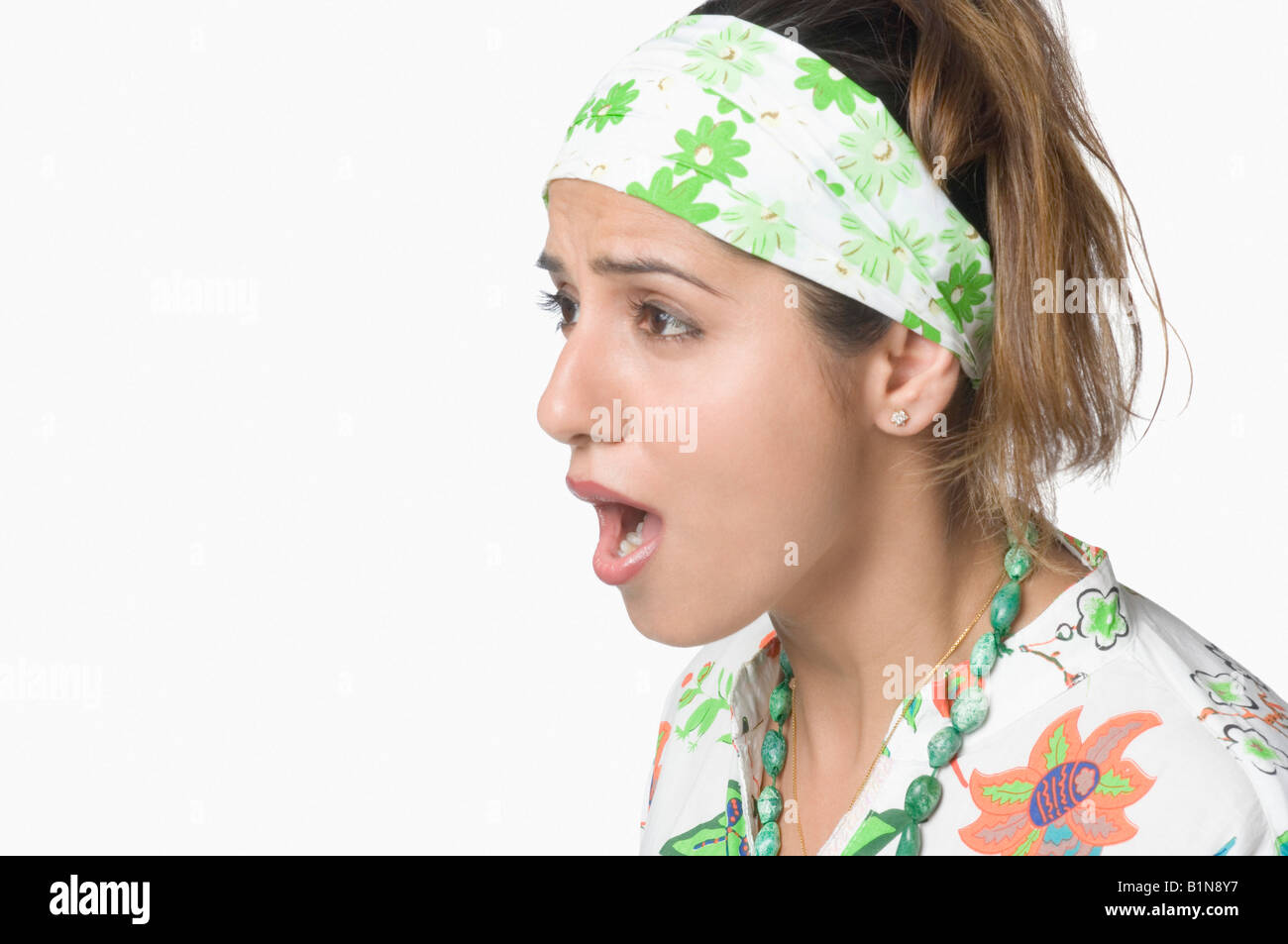 Side profile of a young woman looking surprised Stock Photo - Alamy