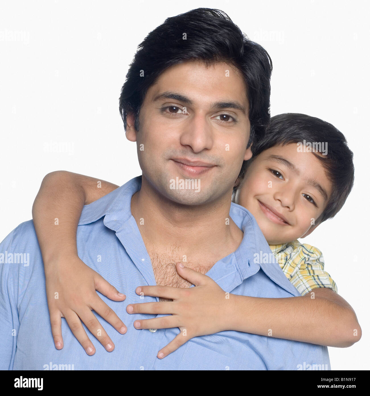 Portrait of a boy hugging his father from behind Stock Photo - Alamy
