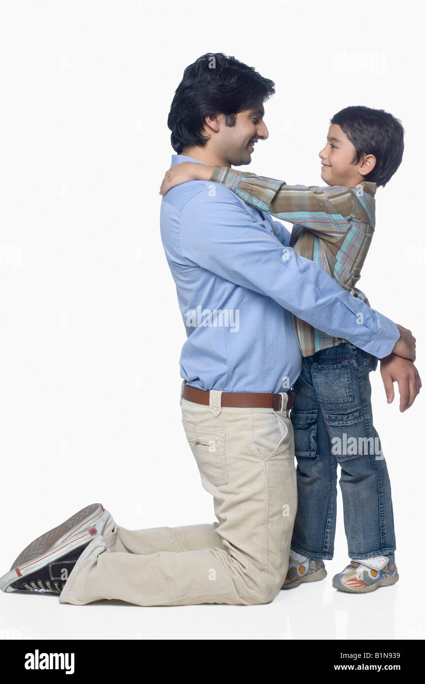 Side profile of a young man hugging his son Stock Photo - Alamy