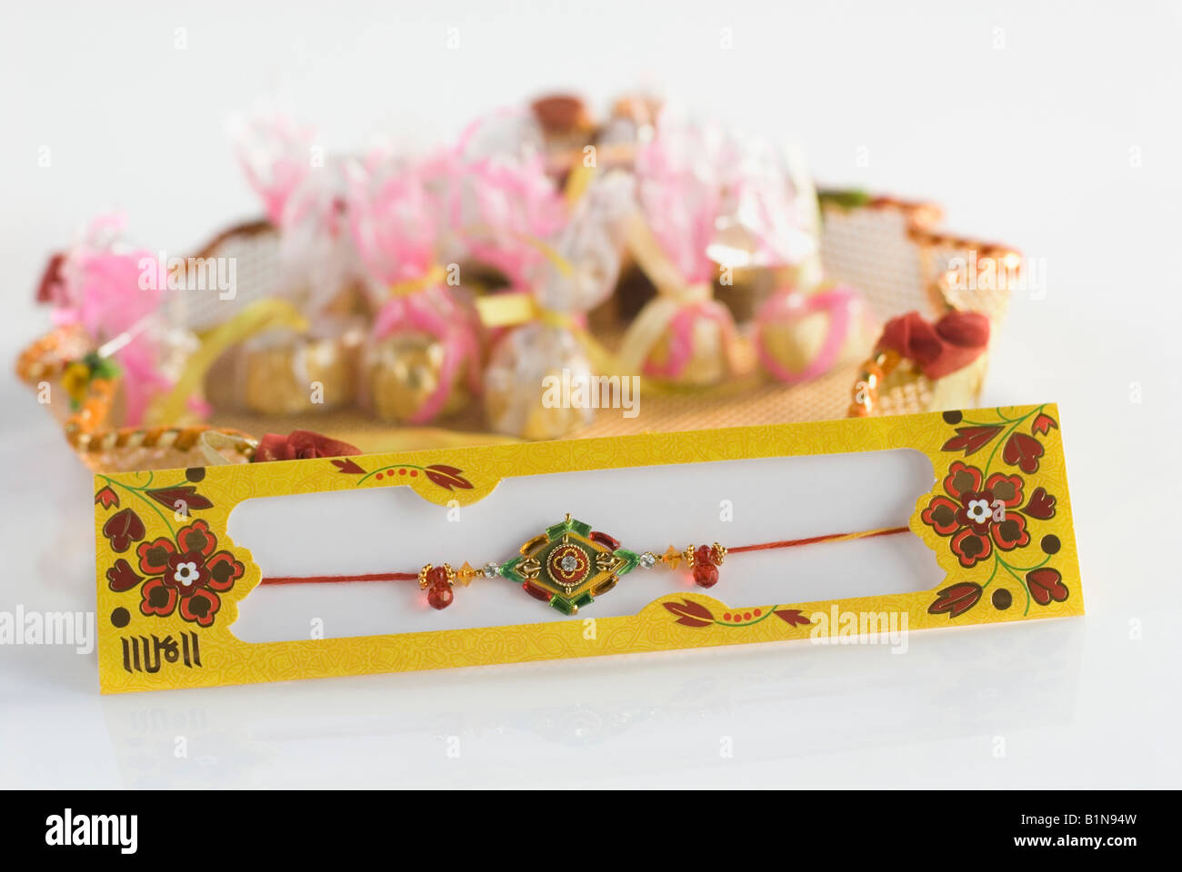 Close-up of a rakhi with sweets Stock Photo - Alamy