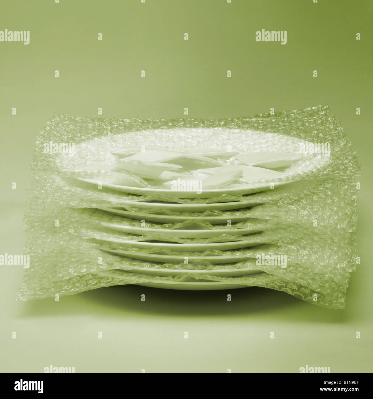 Close-up of a stack of plates wrapped in a bubble wrap Stock Photo - Alamy