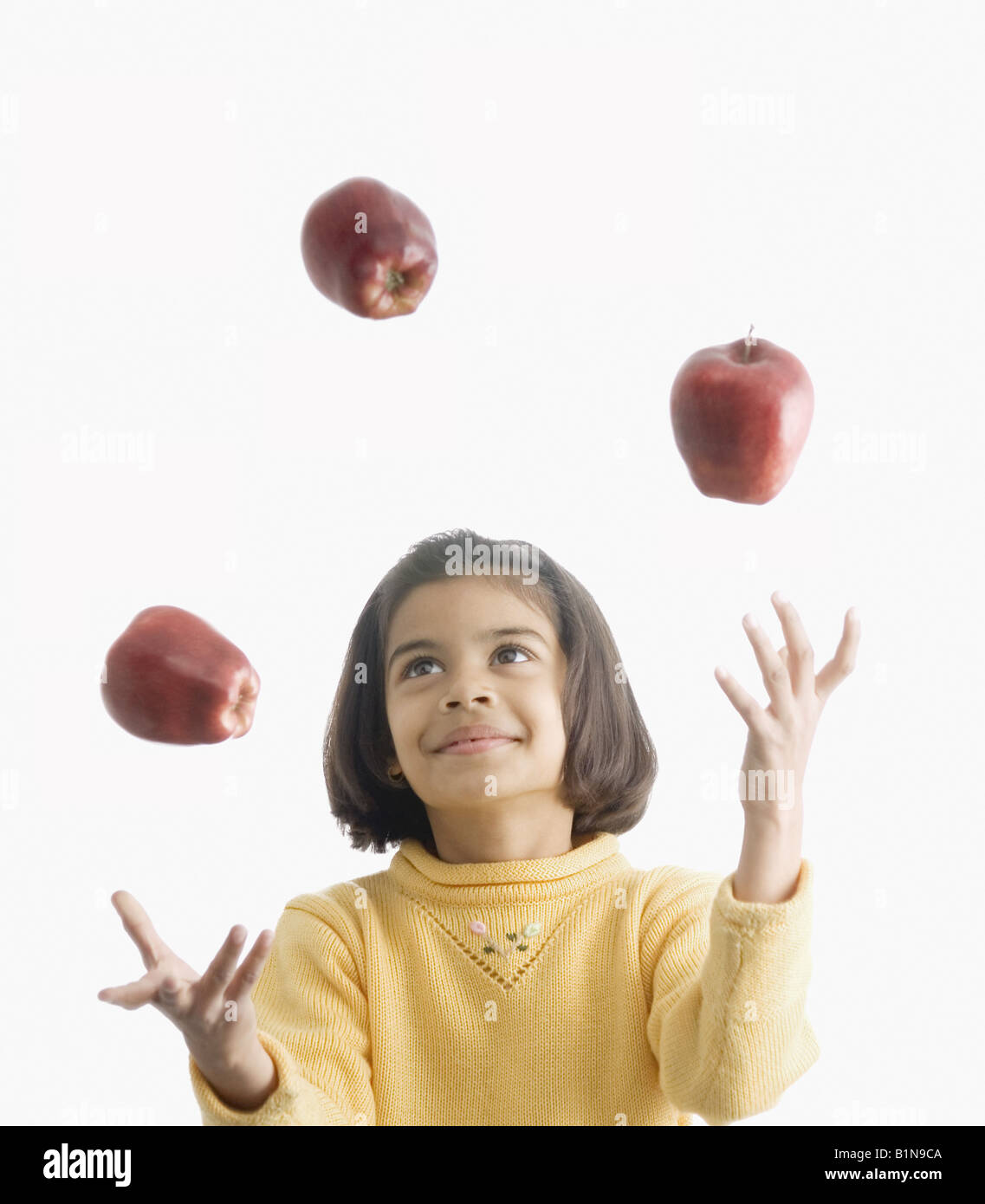 Girl juggling with apples Stock Photo - Alamy