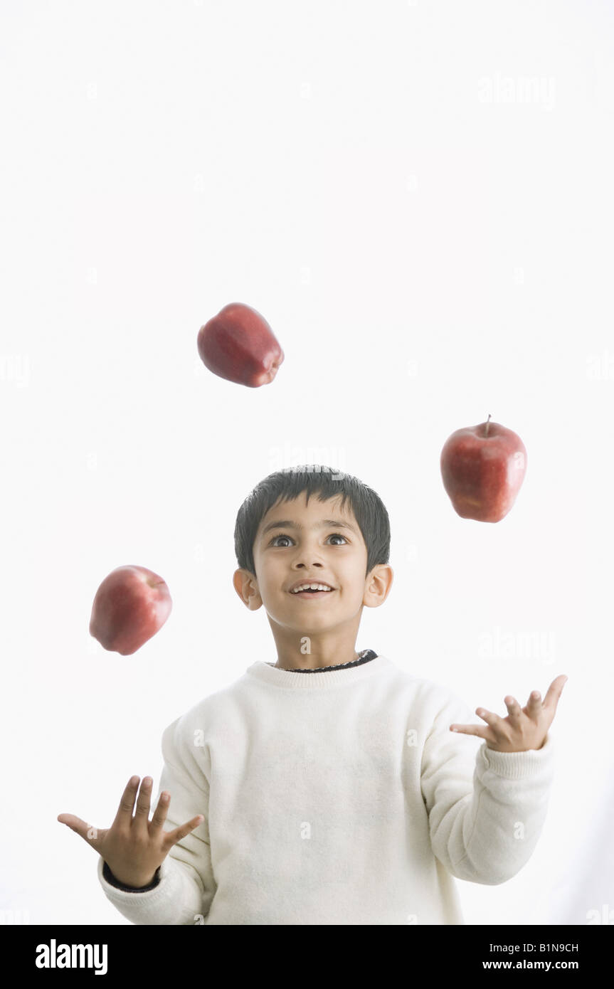 Boy juggling with apples Stock Photo - Alamy