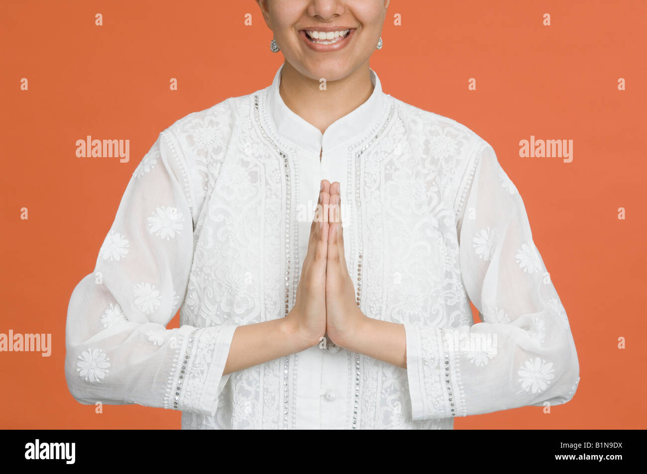Close-up of a young woman greeting and smiling Stock Photo - Alamy