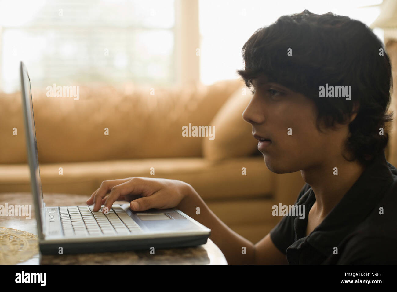 Side profile of a teenage boy using a laptop Stock Photo - Alamy
