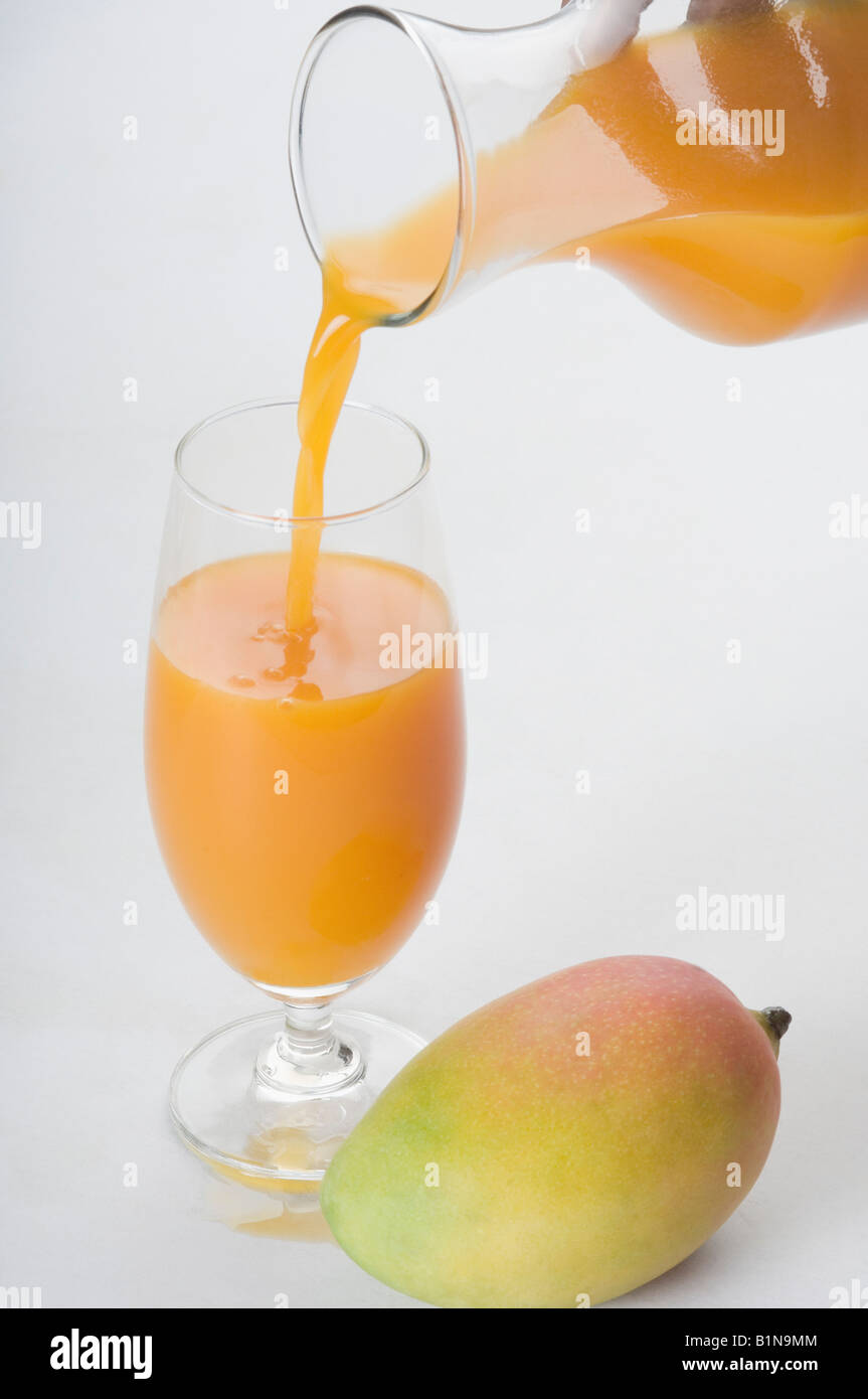 Close-up of mango with a glass of mango shake Stock Photo - Alamy