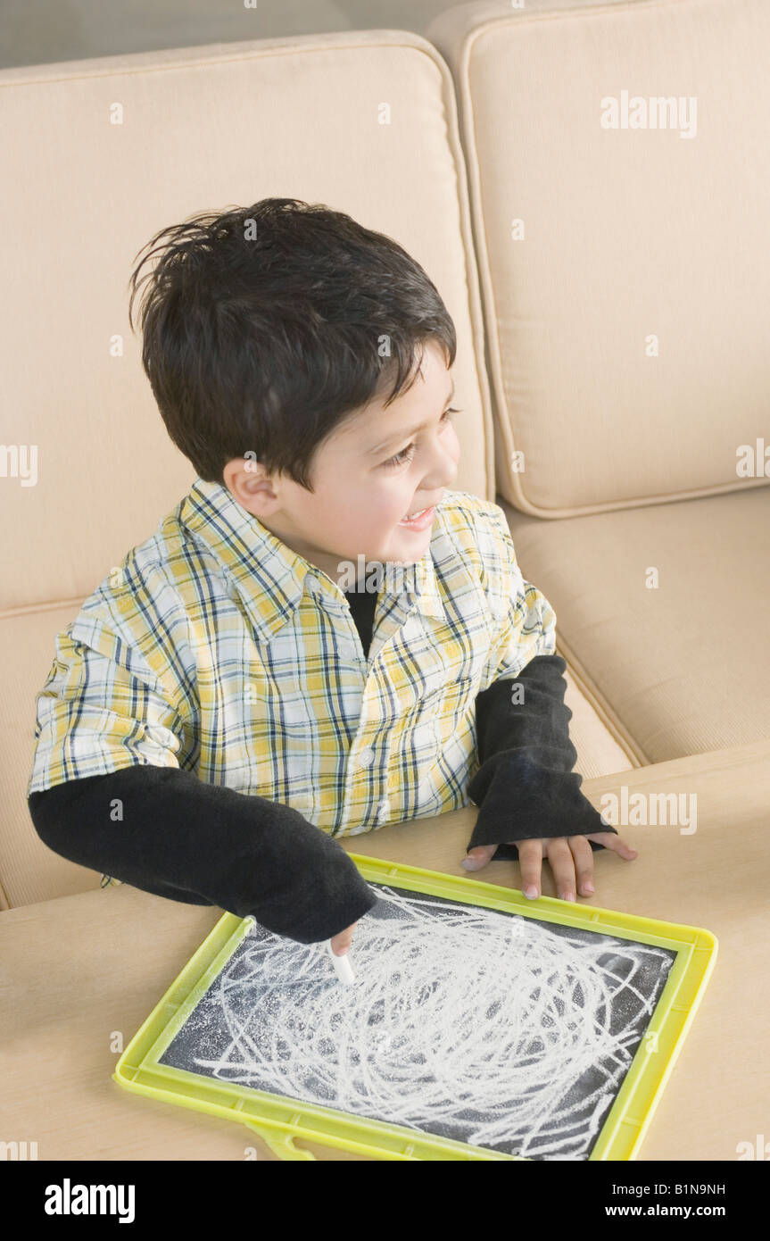 Boy writing on a slate Stock Photo - Alamy