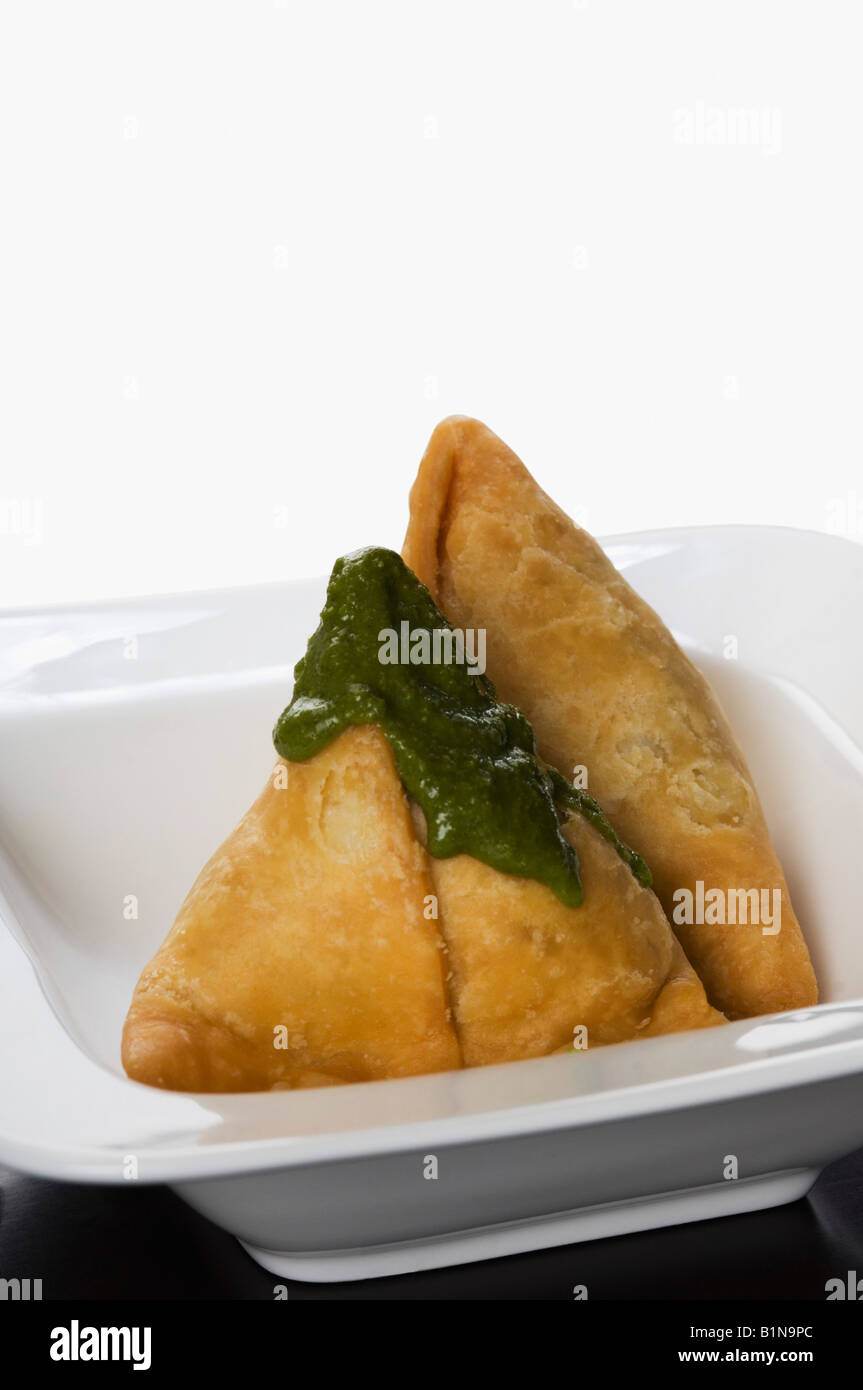 Close-up of two samosas with sauce Stock Photo - Alamy