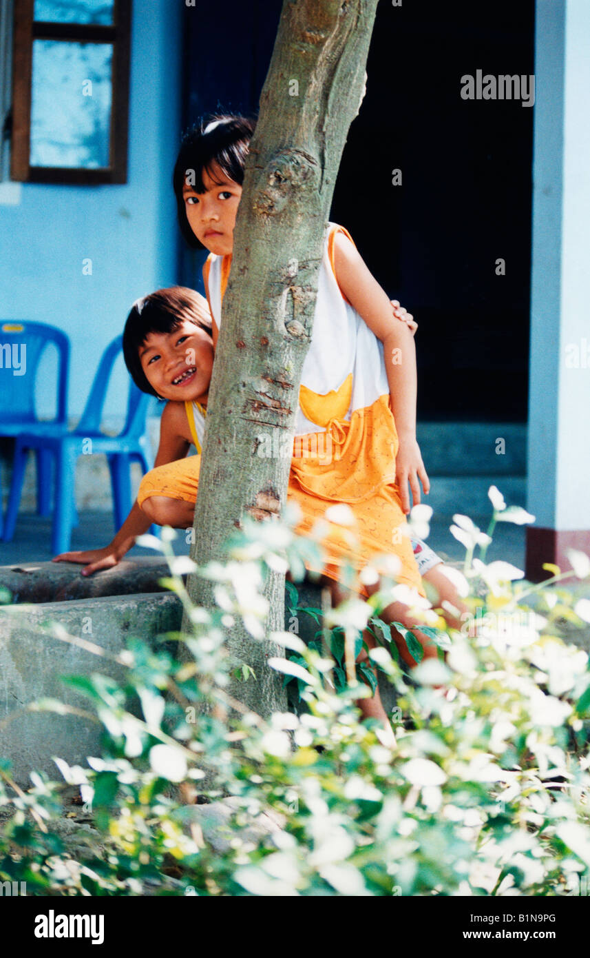 Vietnam Hue Two Children Looking From Behind Tree Stock Photo - Alamy