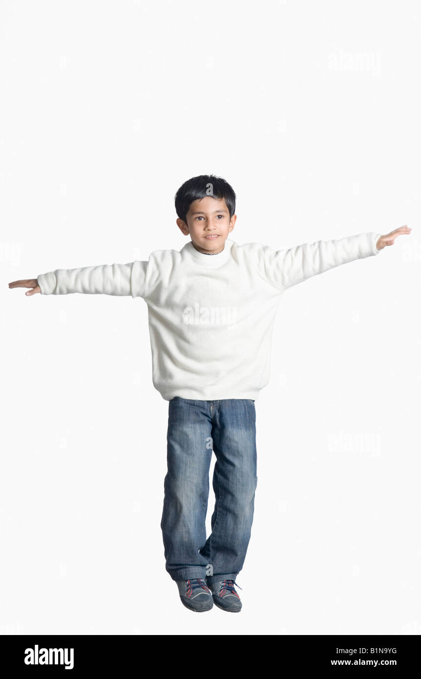 Boy dancing with his arms outstretched Stock Photo - Alamy