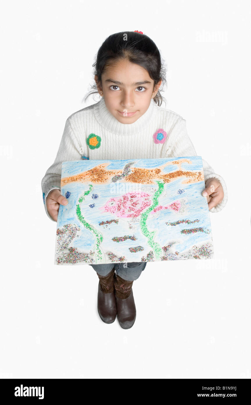 High angle view of a girl showing a drawing Stock Photo - Alamy